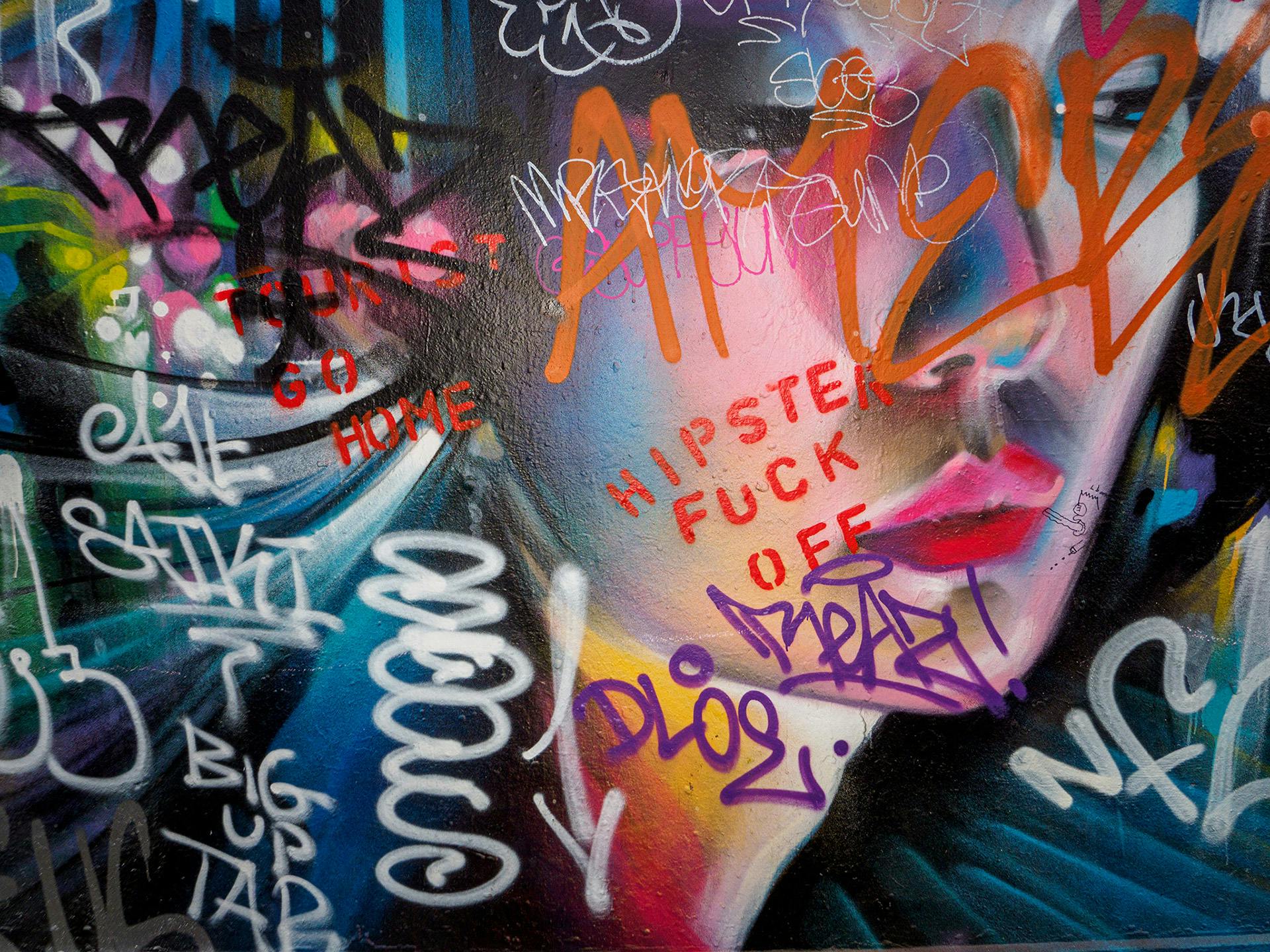 Dougie Wallace aims his flashgun at Brick Lane in a new photo book